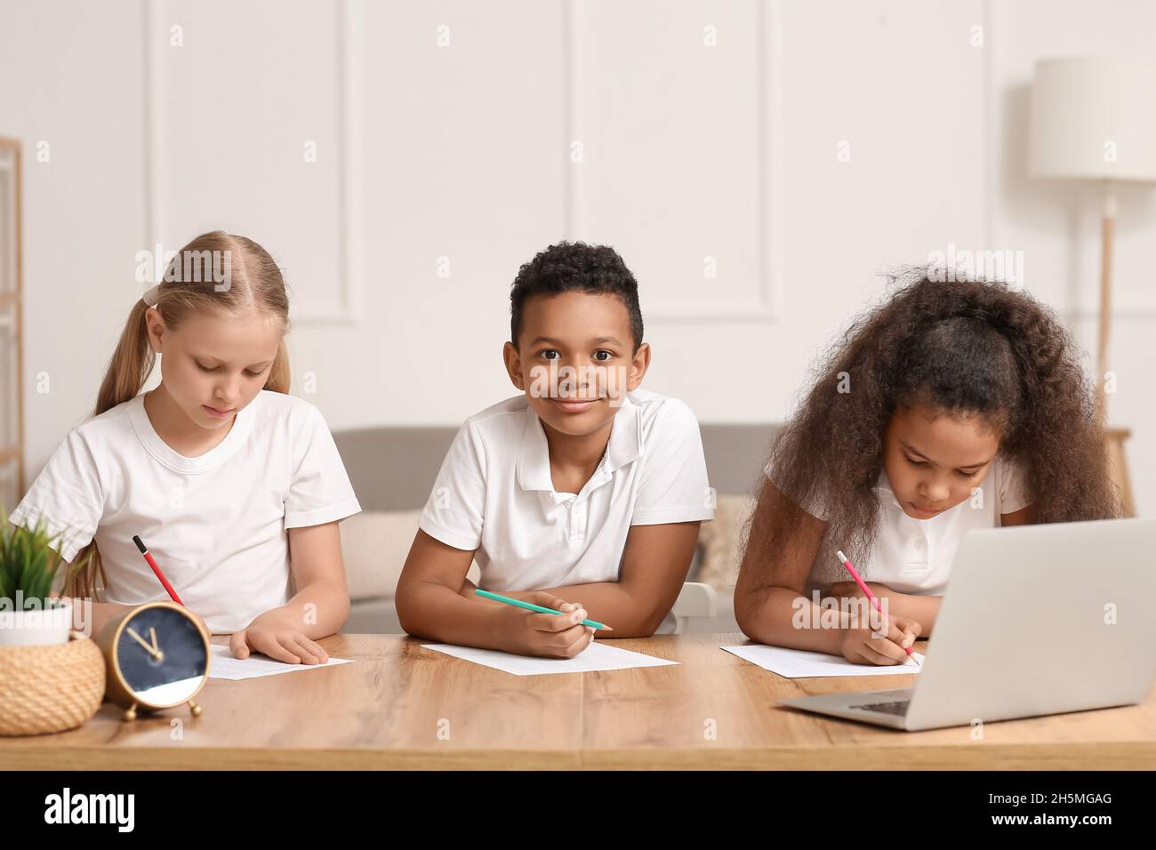 Little pupils studying online at home Stock Photo - Alamy