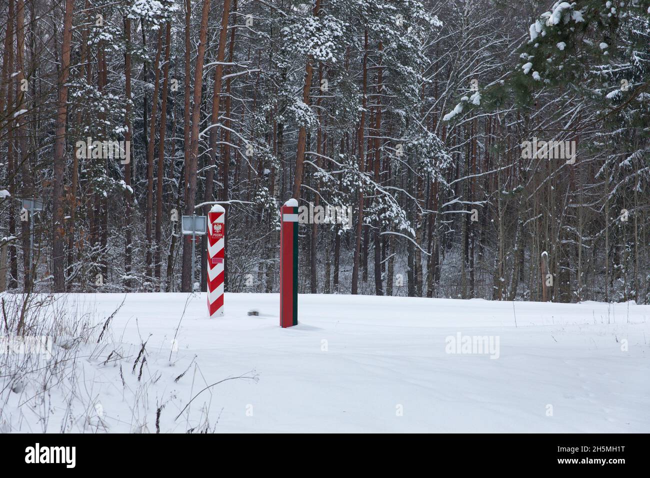 Boundary pillars of Belarus and Poland on the border in a winter field ...