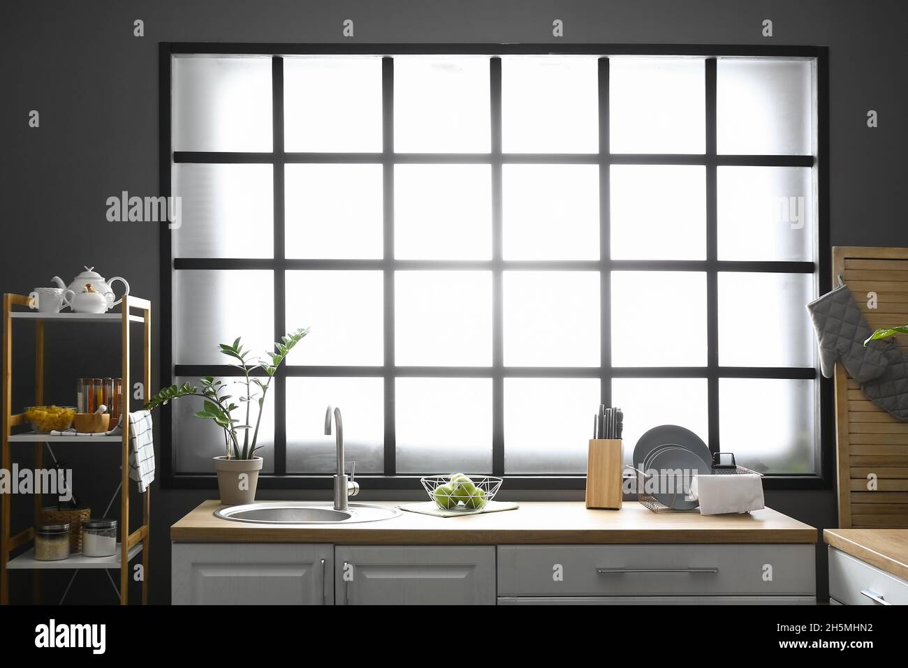 Interior of modern kitchen with counters and big window Stock Photo - Alamy