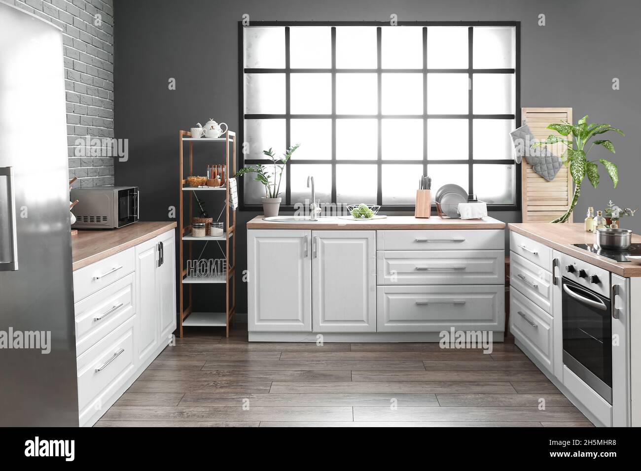 Interior of modern kitchen with white counters and big window Stock ...