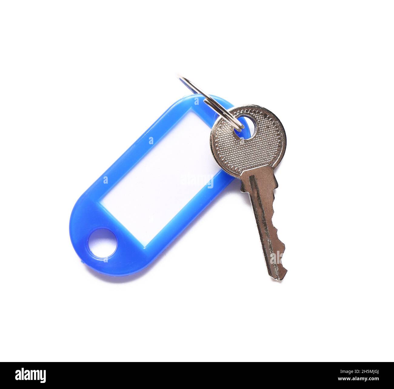 Metallic key with plastic tag on white background Stock Photo - Alamy