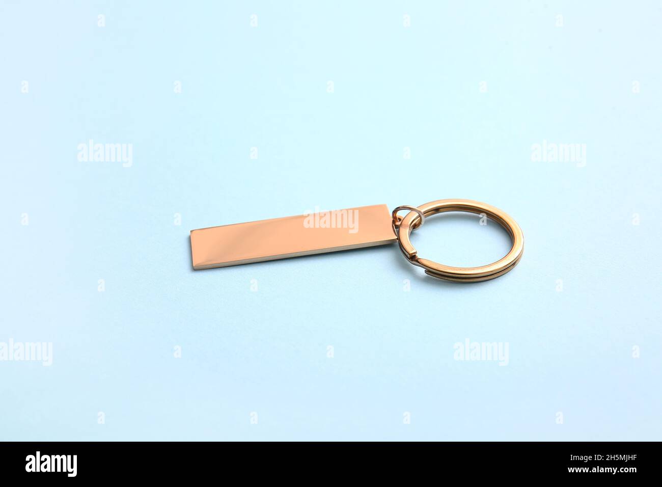 Stylish key chain on blue background Stock Photo - Alamy