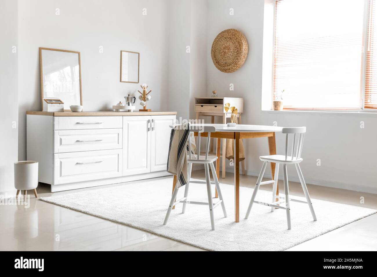 Interior of modern light room with dining table Stock Photo - Alamy