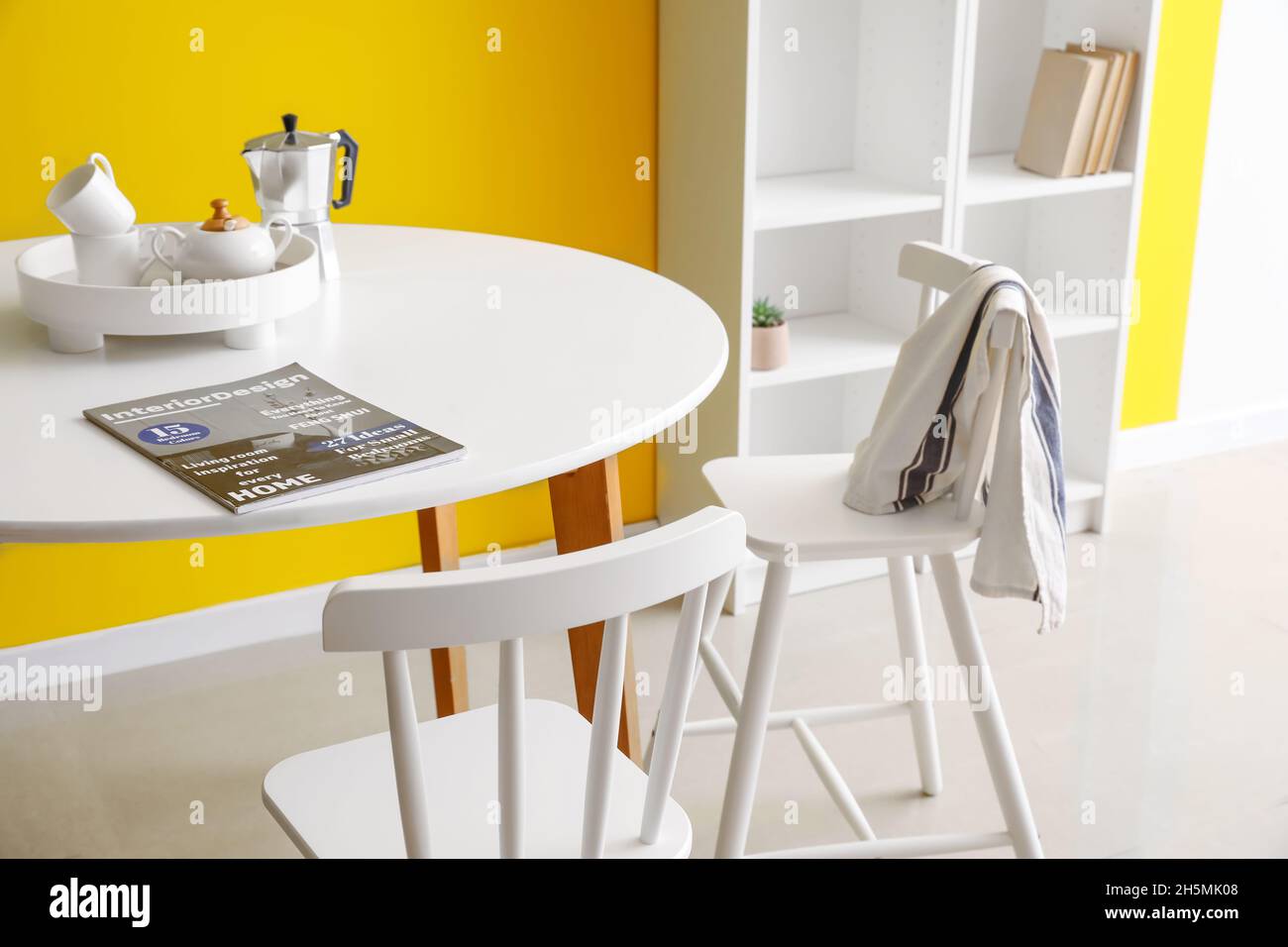 Interior of modern room with dining table Stock Photo - Alamy