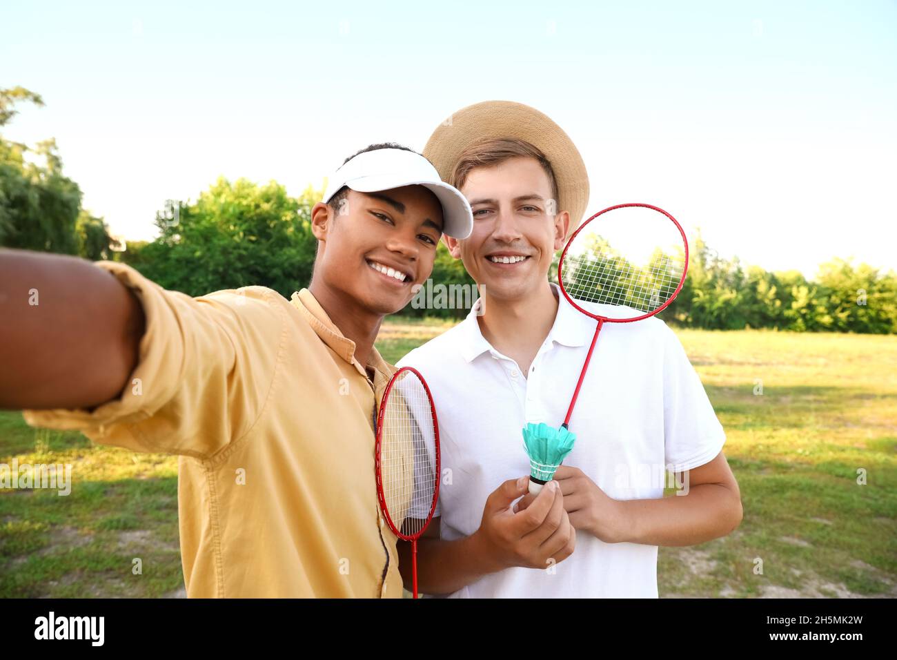 Male badminton players taking selfie outdoors Stock Photo - Alamy