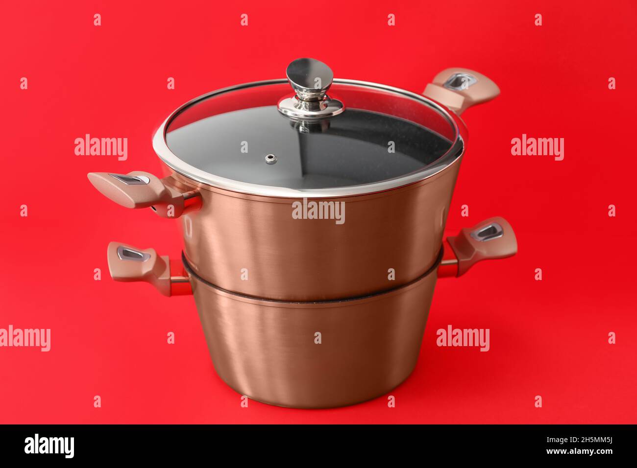 Cooking pots with cover on color background Stock Photo - Alamy