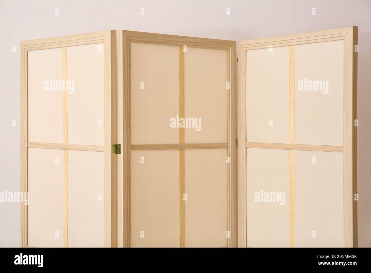Stylish folding screen near wall in room interior Stock Photo - Alamy