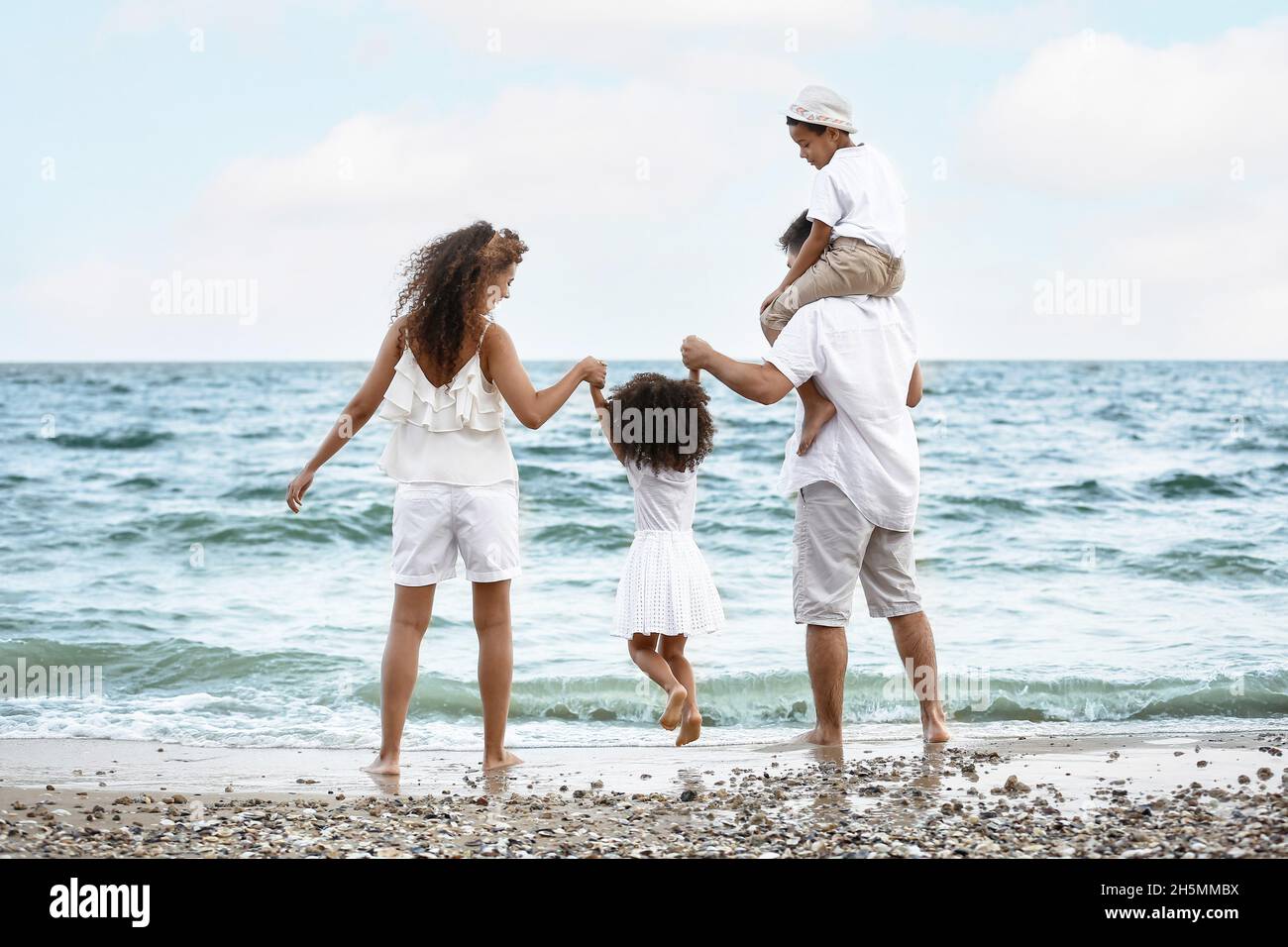 Happy family on sea beach Stock Photo - Alamy