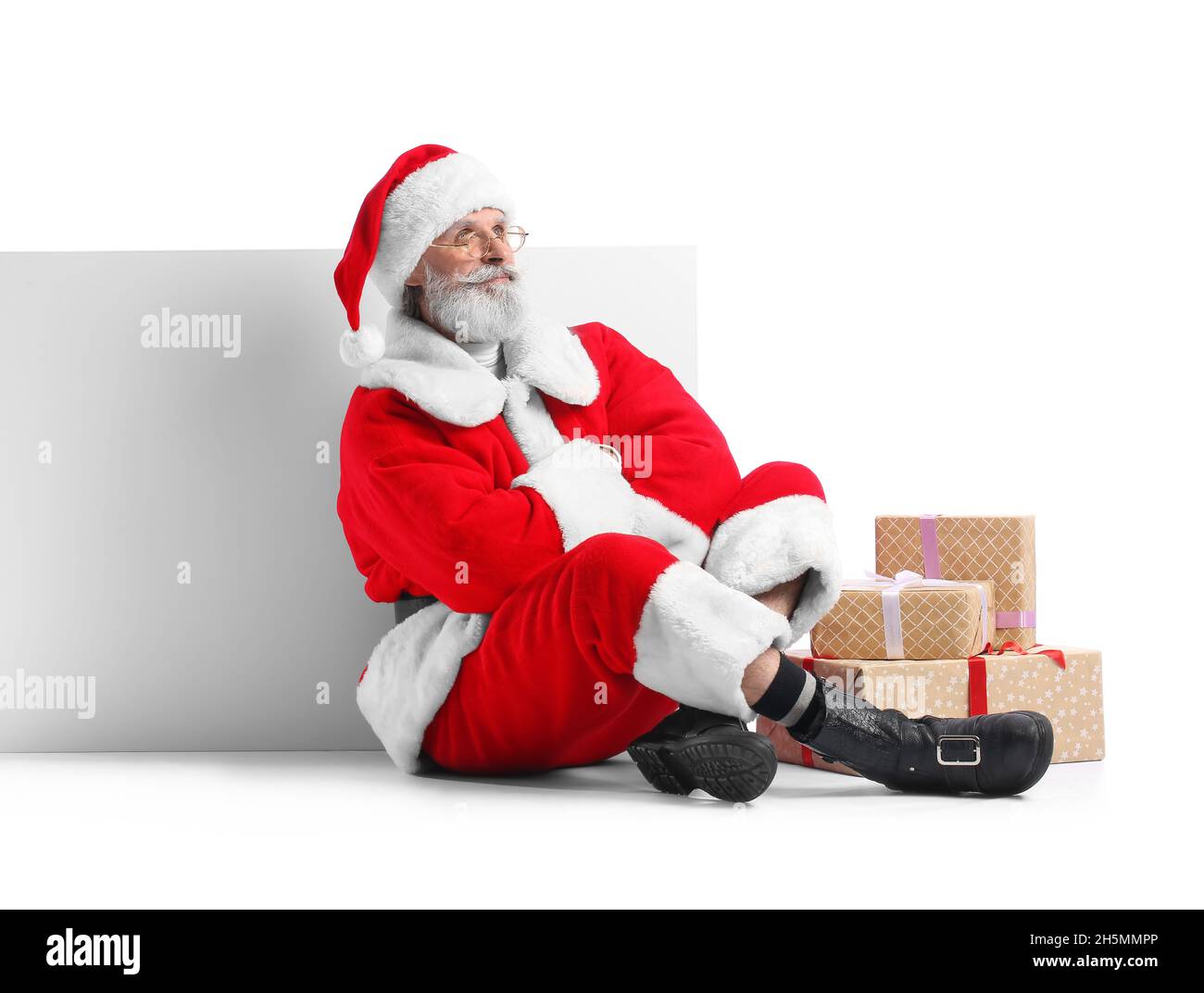 Santa Claus with blank poster and gift boxes on white background Stock ...