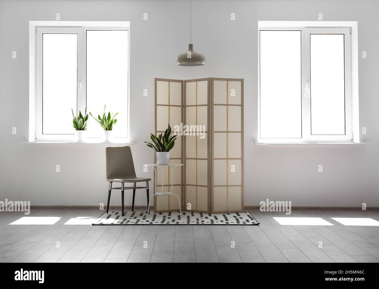 Interior of stylish room with folding screen Stock Photo - Alamy