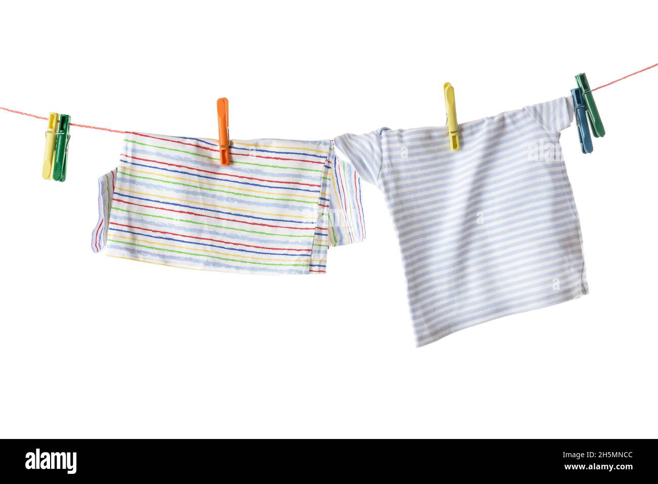 Child clothes hanging on rope with clothespins against white background ...