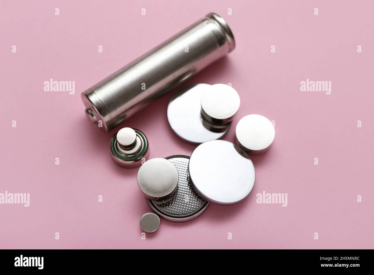 Different batteries on pink background Stock Photo - Alamy