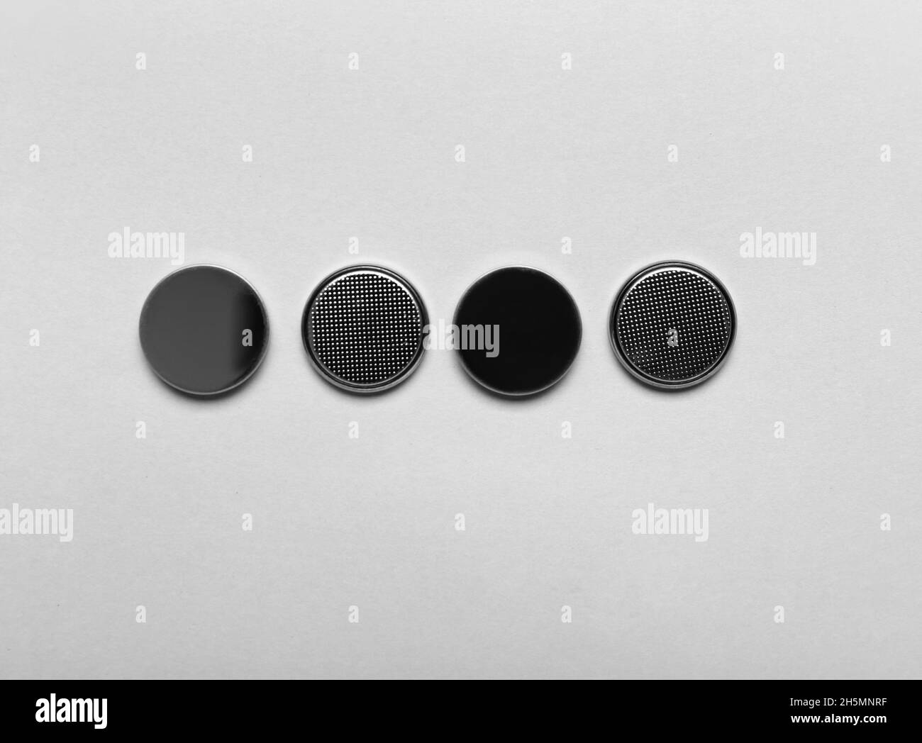 Lithium button cell batteries on light background Stock Photo - Alamy