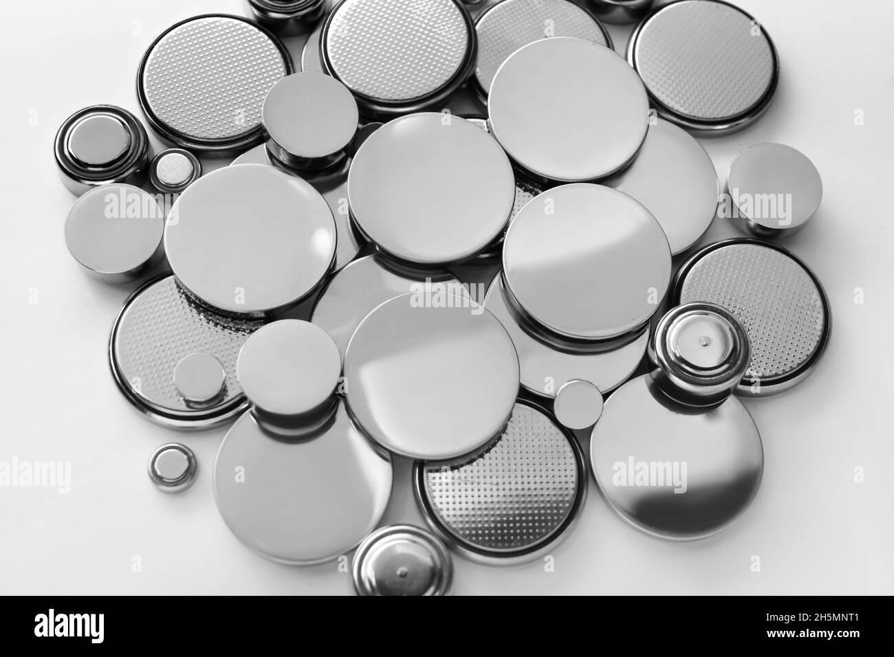 Lithium button cell batteries on light background Stock Photo - Alamy