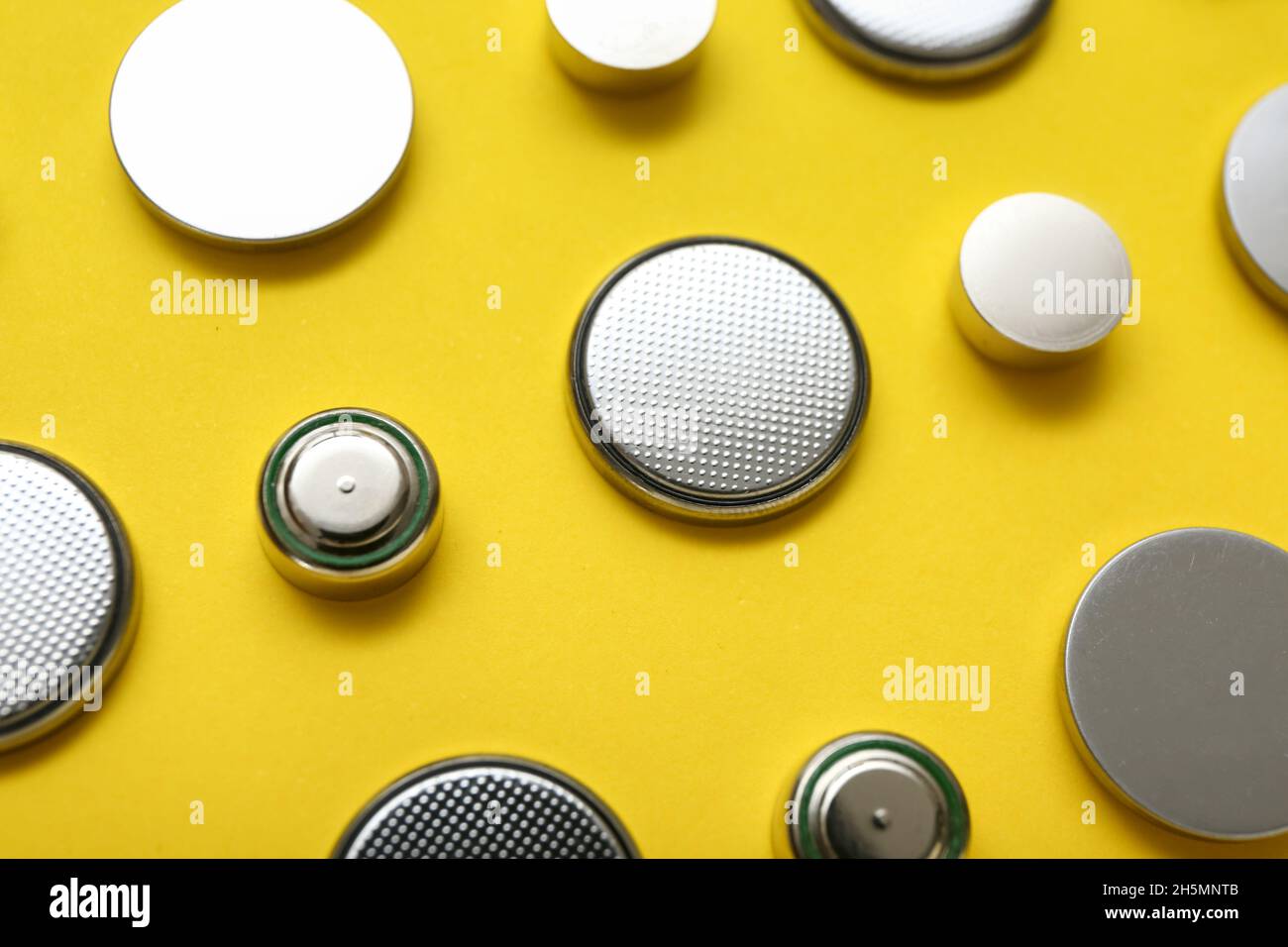 Lithium button cell batteries on yellow background, closeup Stock Photo ...