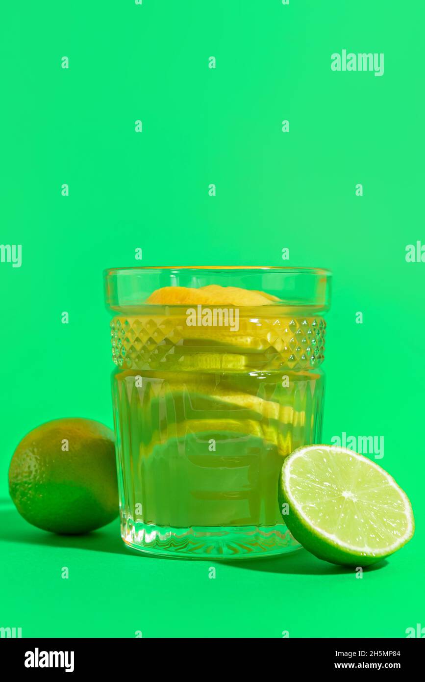 Glass of fresh lemonade and limes on color background Stock Photo - Alamy