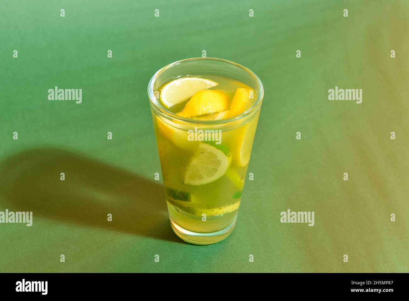 Glass of tasty lemonade on color background Stock Photo - Alamy