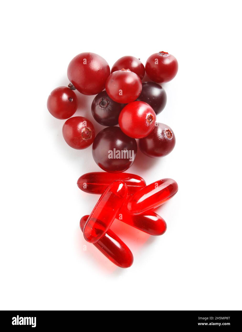 Cranberry pills and heap of berries on white background Stock Photo - Alamy