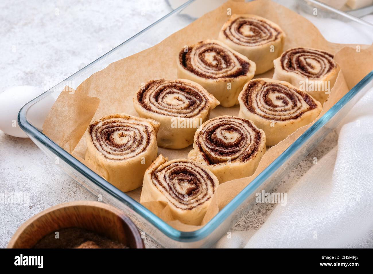Baking dish of uncooked cinnamon rolls on white background Stock Photo ...