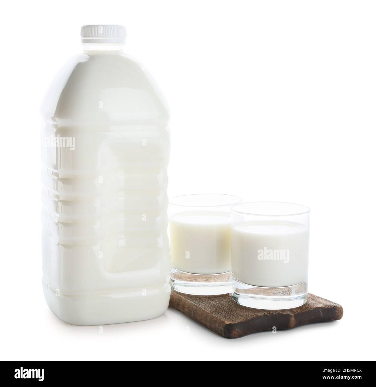 Gallon bottle and glasses of milk on white background Stock Photo - Alamy