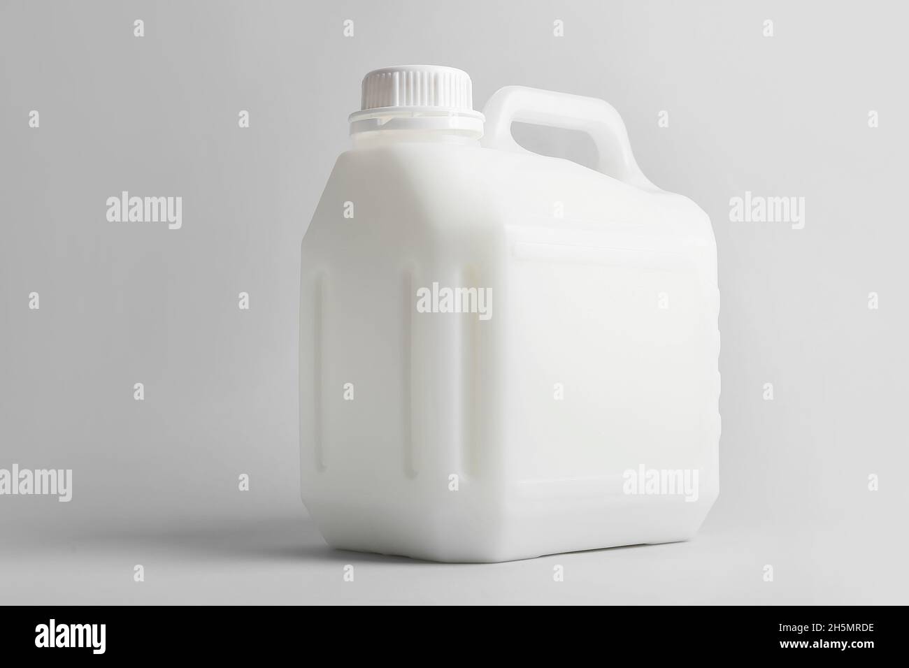 Gallon bottle of milk on light background Stock Photo - Alamy