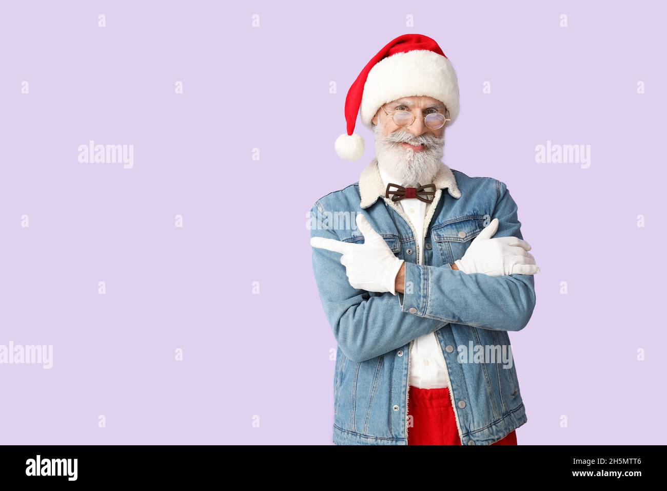 Cool Santa Claus pointing at something on color background Stock Photo ...