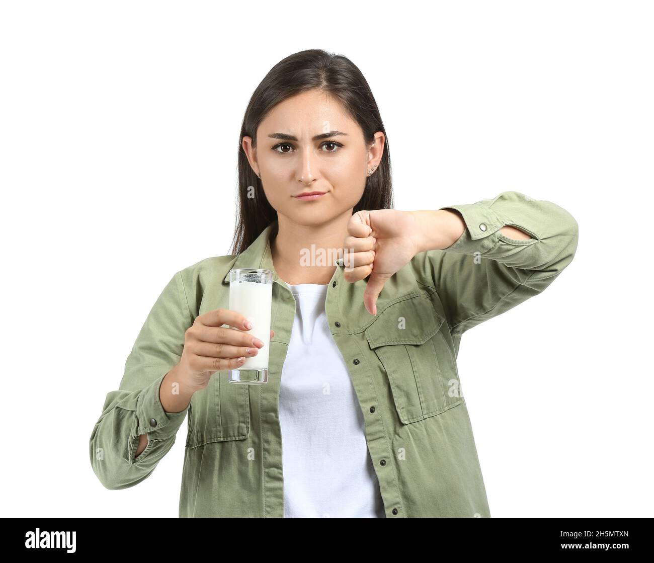 Young woman refusing to drink milk on white background Stock Photo - Alamy