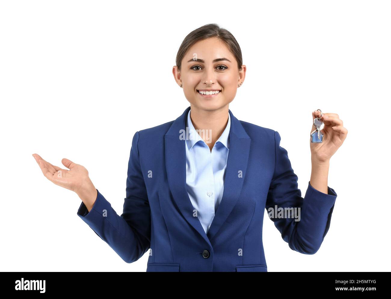 Female real estate agent with keys from new house on white background ...