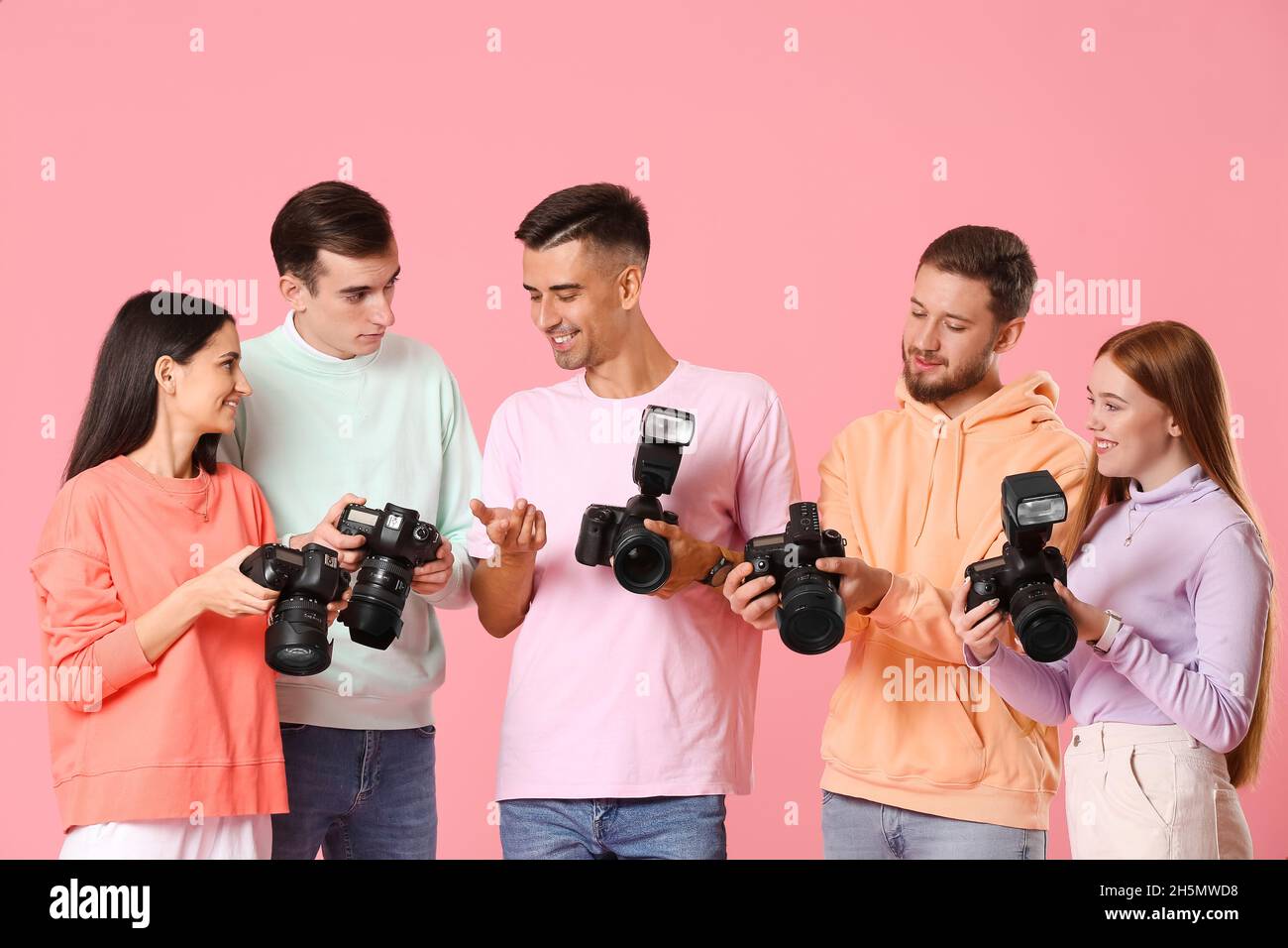 Group of photographers on color background Stock Photo - Alamy
