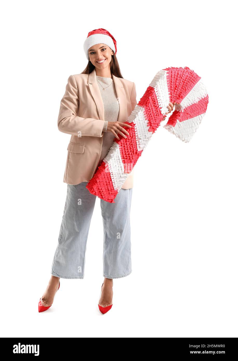 Beautiful woman in Santa hat and with candy cane pinata on white ...
