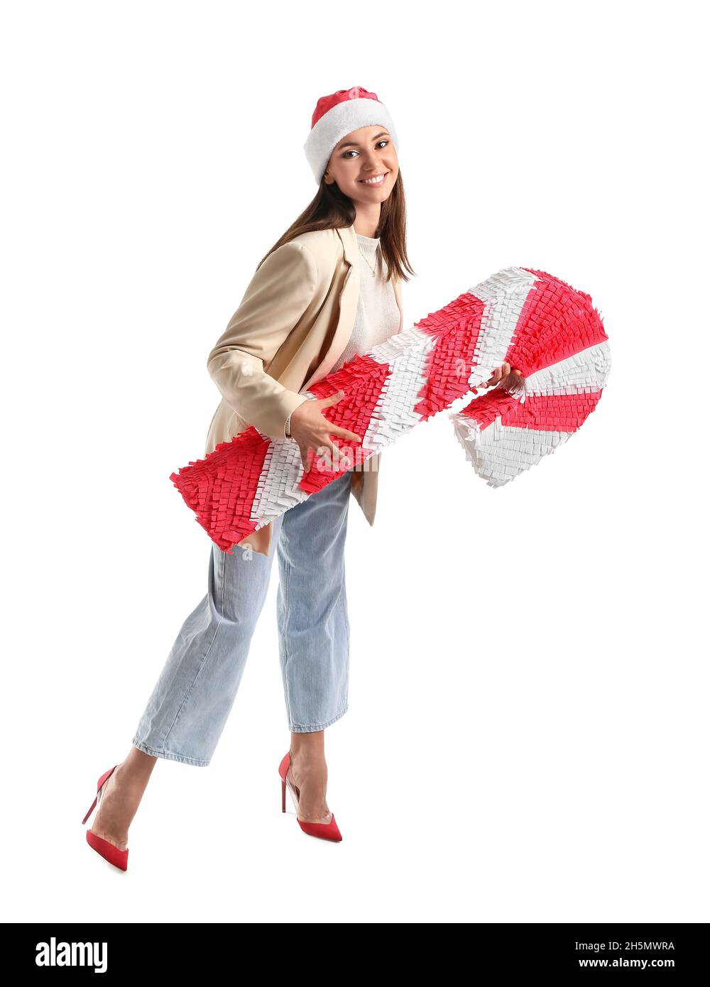 Beautiful woman in Santa hat and with candy cane pinata on white ...