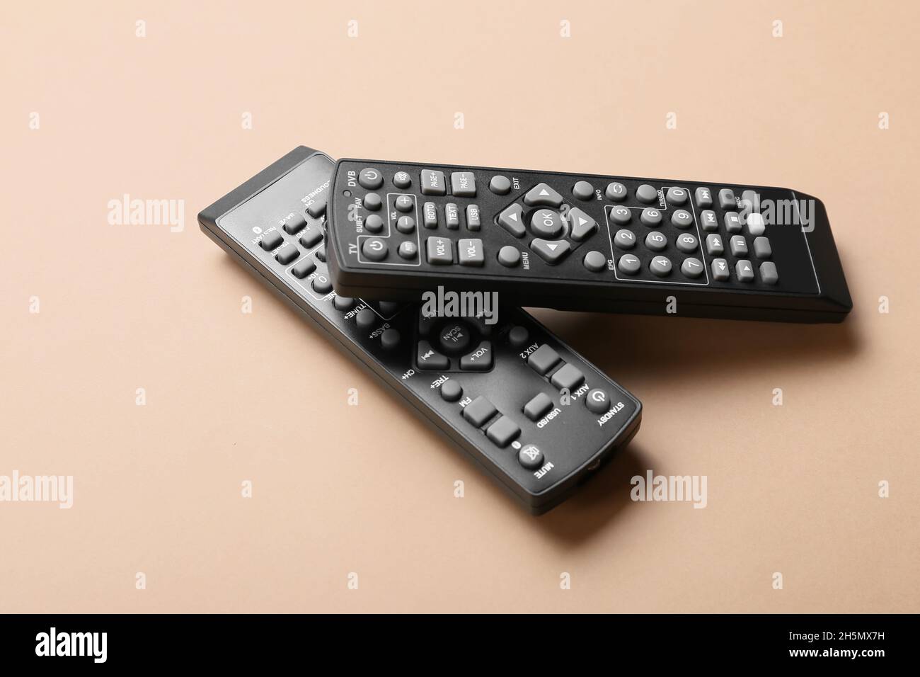 Modern TV remote controllers on color background Stock Photo - Alamy