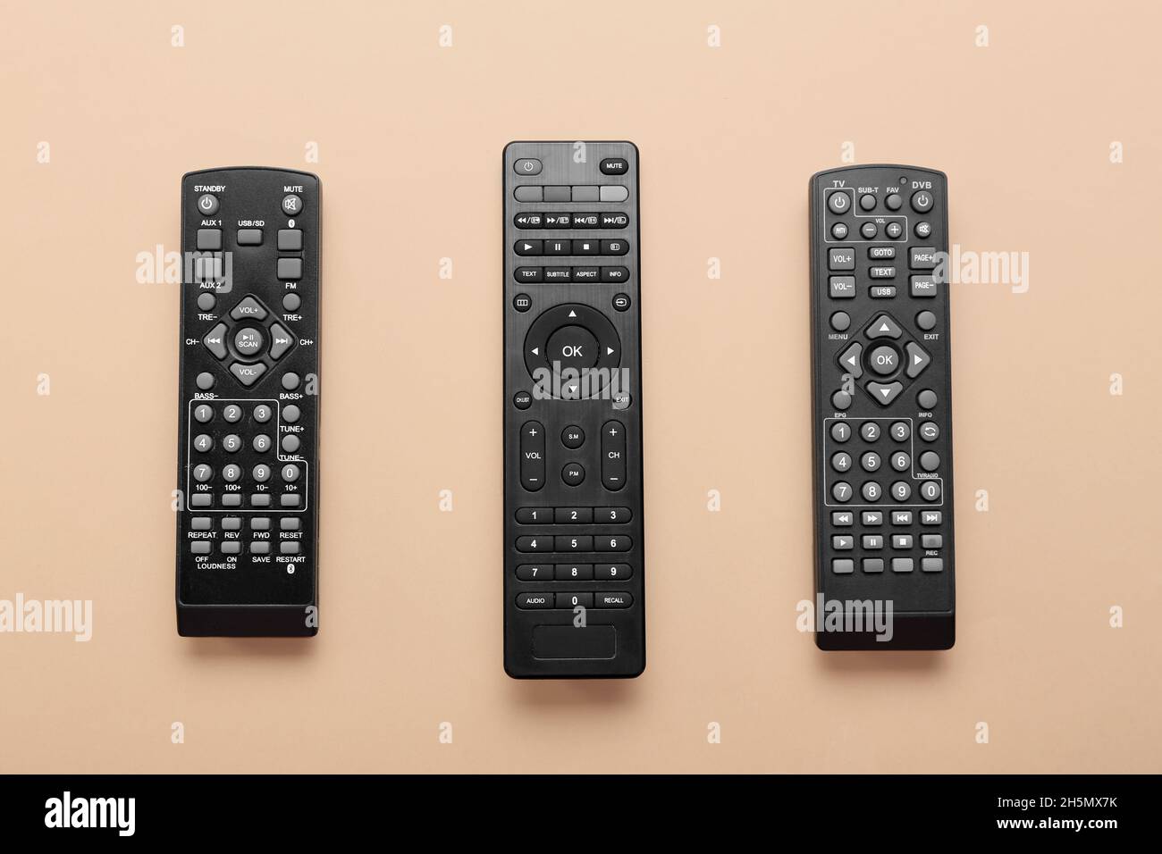 Different modern TV remote controllers on color background Stock Photo ...