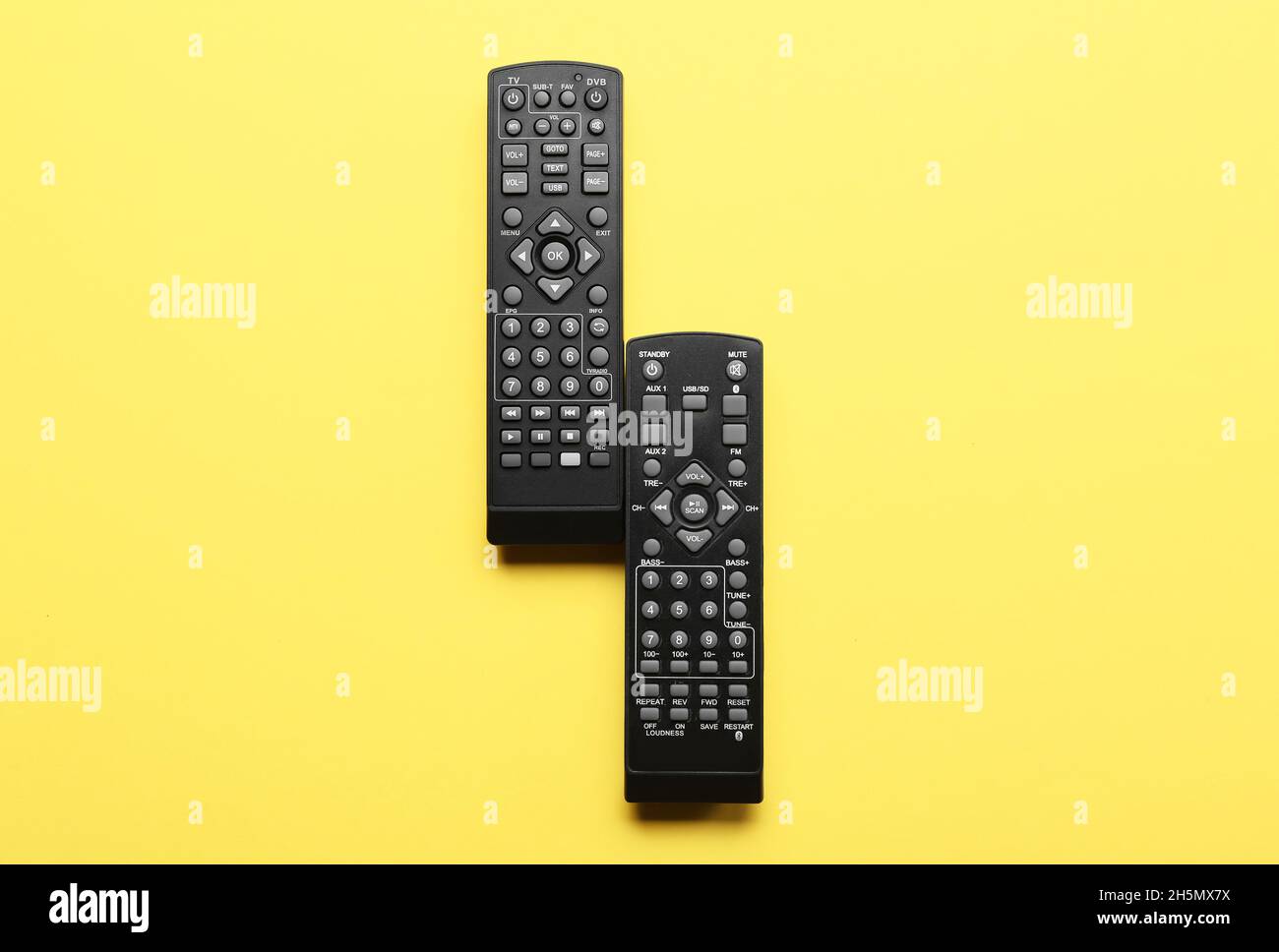Modern TV remote controllers on color background Stock Photo - Alamy