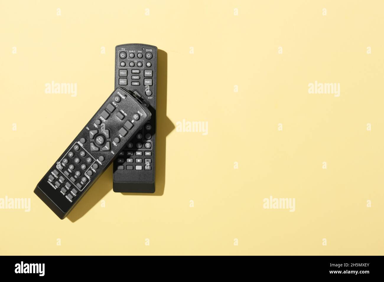 Different TV remote controllers on color background Stock Photo - Alamy