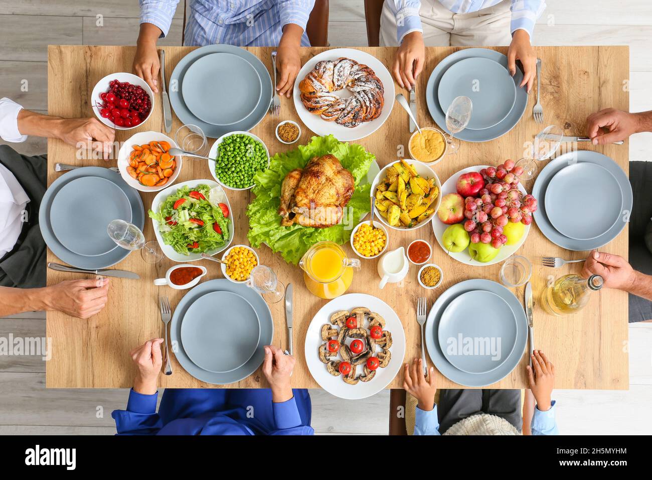 Thanksgiving Day. People eating delicious dinner at festive served ...