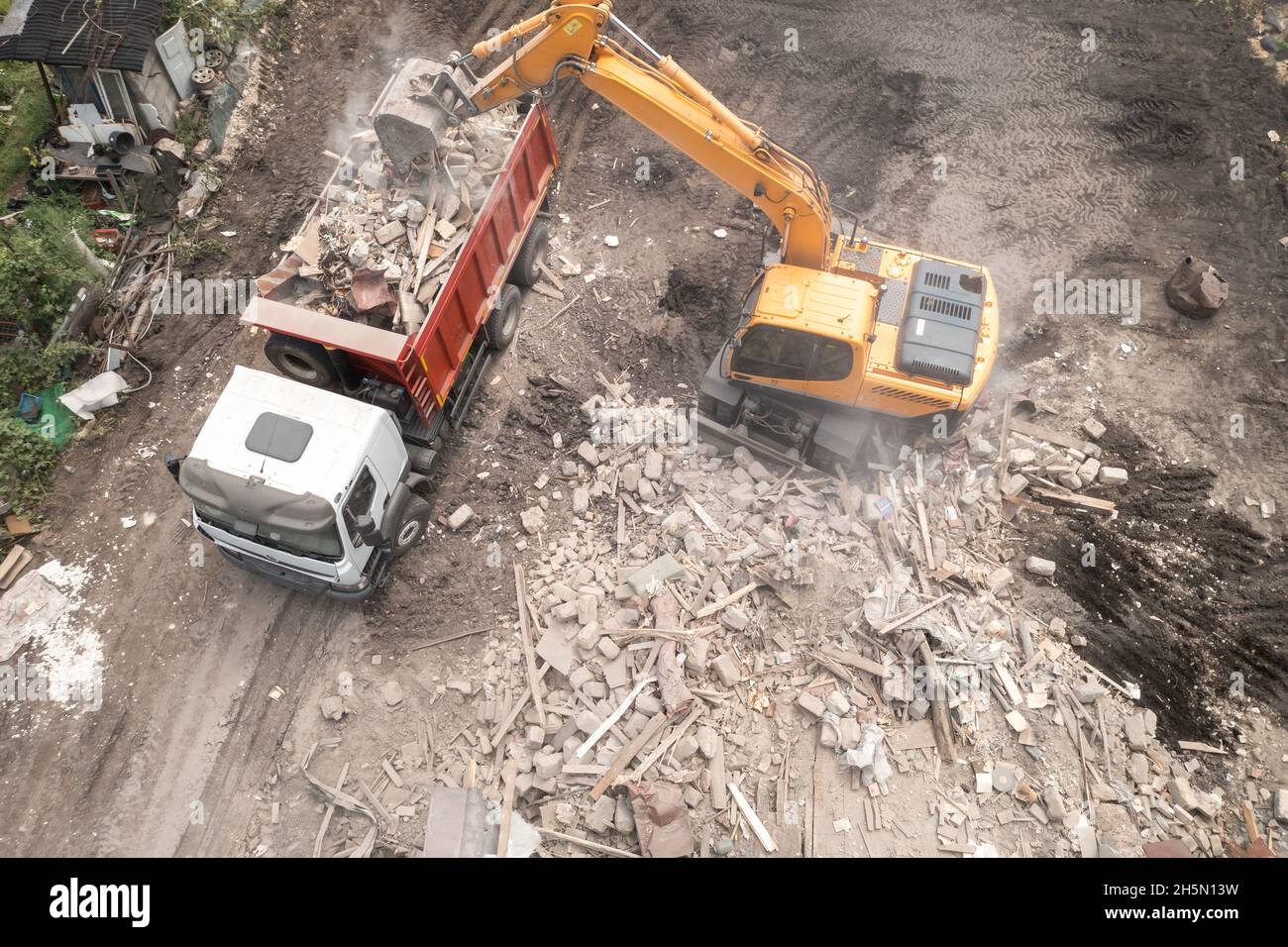 Excavator bucket loads industrial debris into truck. Process of ...