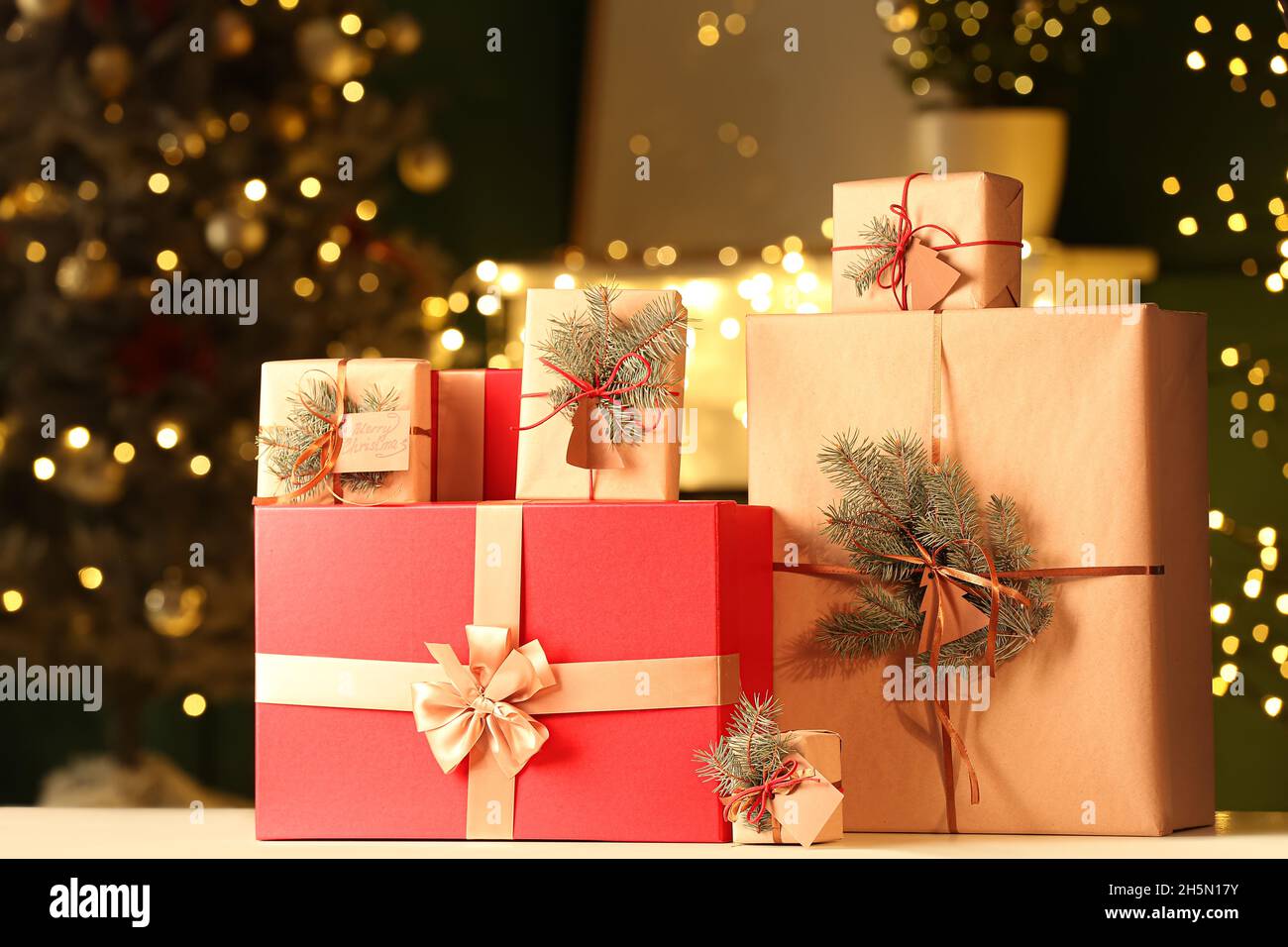 Christmas gift boxes on table in room Stock Photo - Alamy