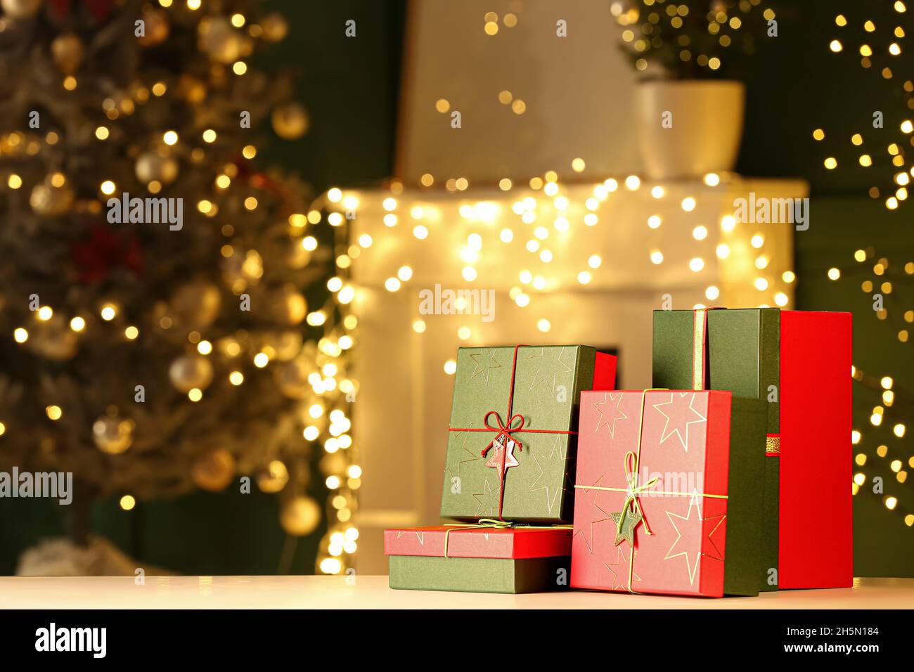 Christmas gift boxes on table in room Stock Photo - Alamy