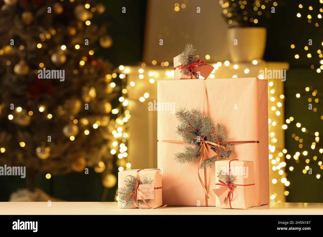 Christmas gift boxes on table in room Stock Photo - Alamy
