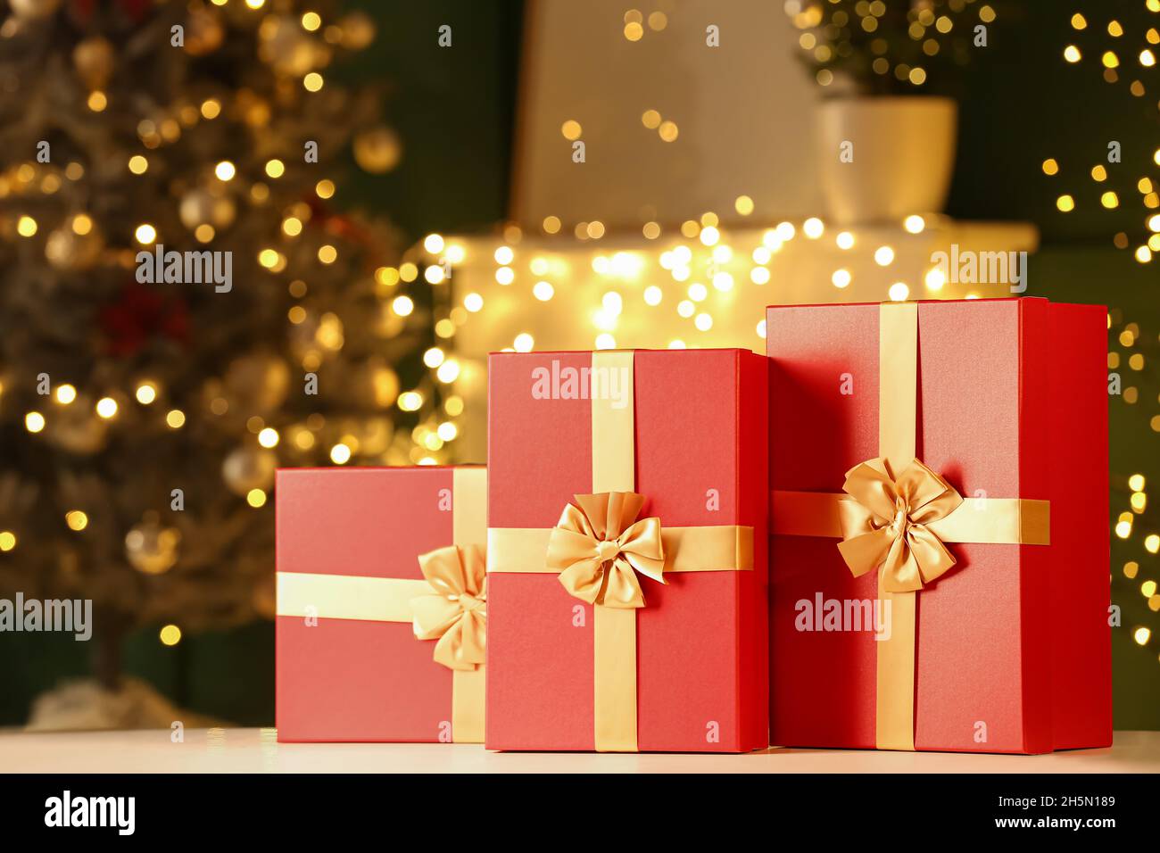 Christmas gift boxes on table in room Stock Photo - Alamy