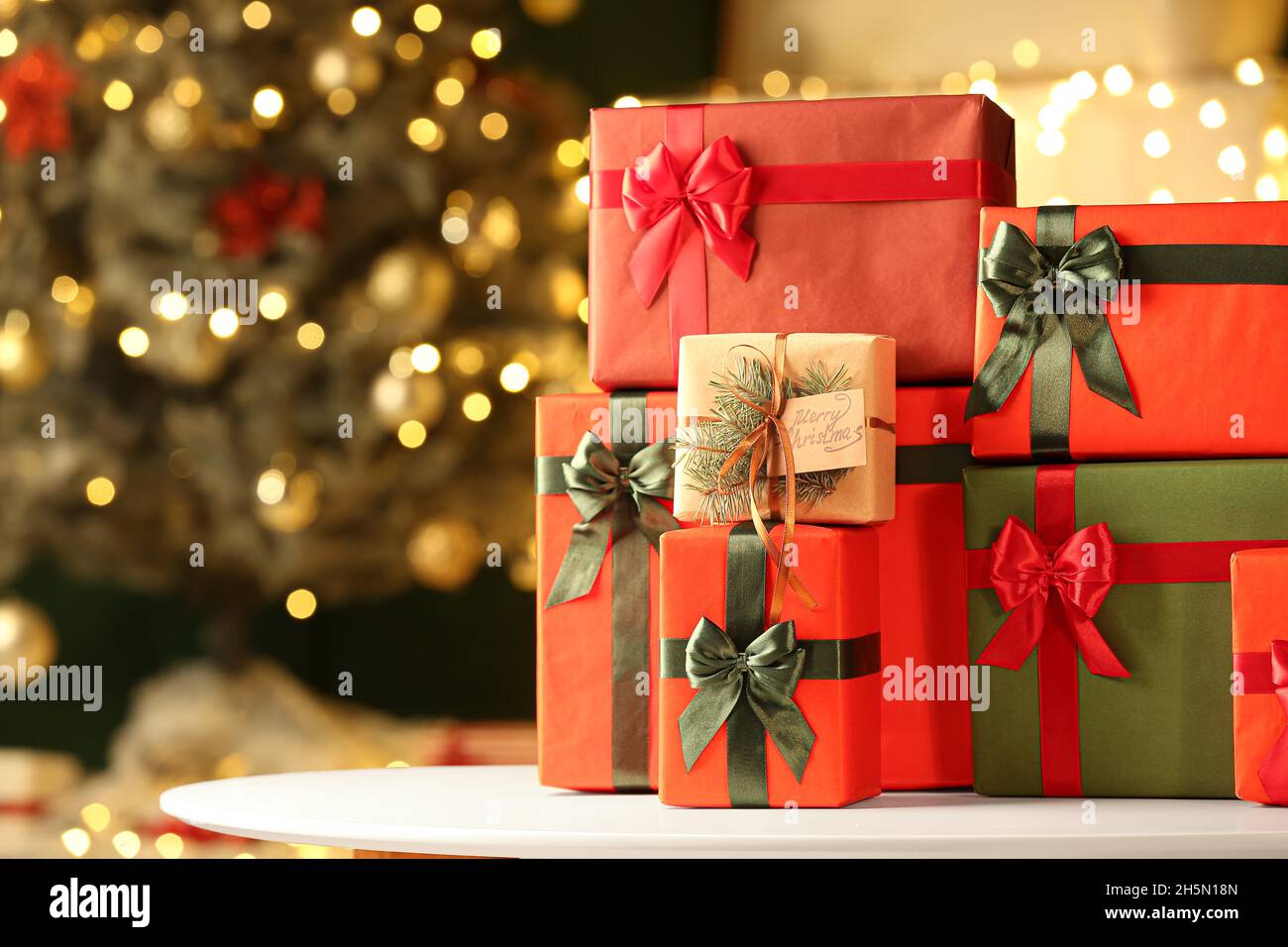 Christmas gift boxes on table in room Stock Photo - Alamy