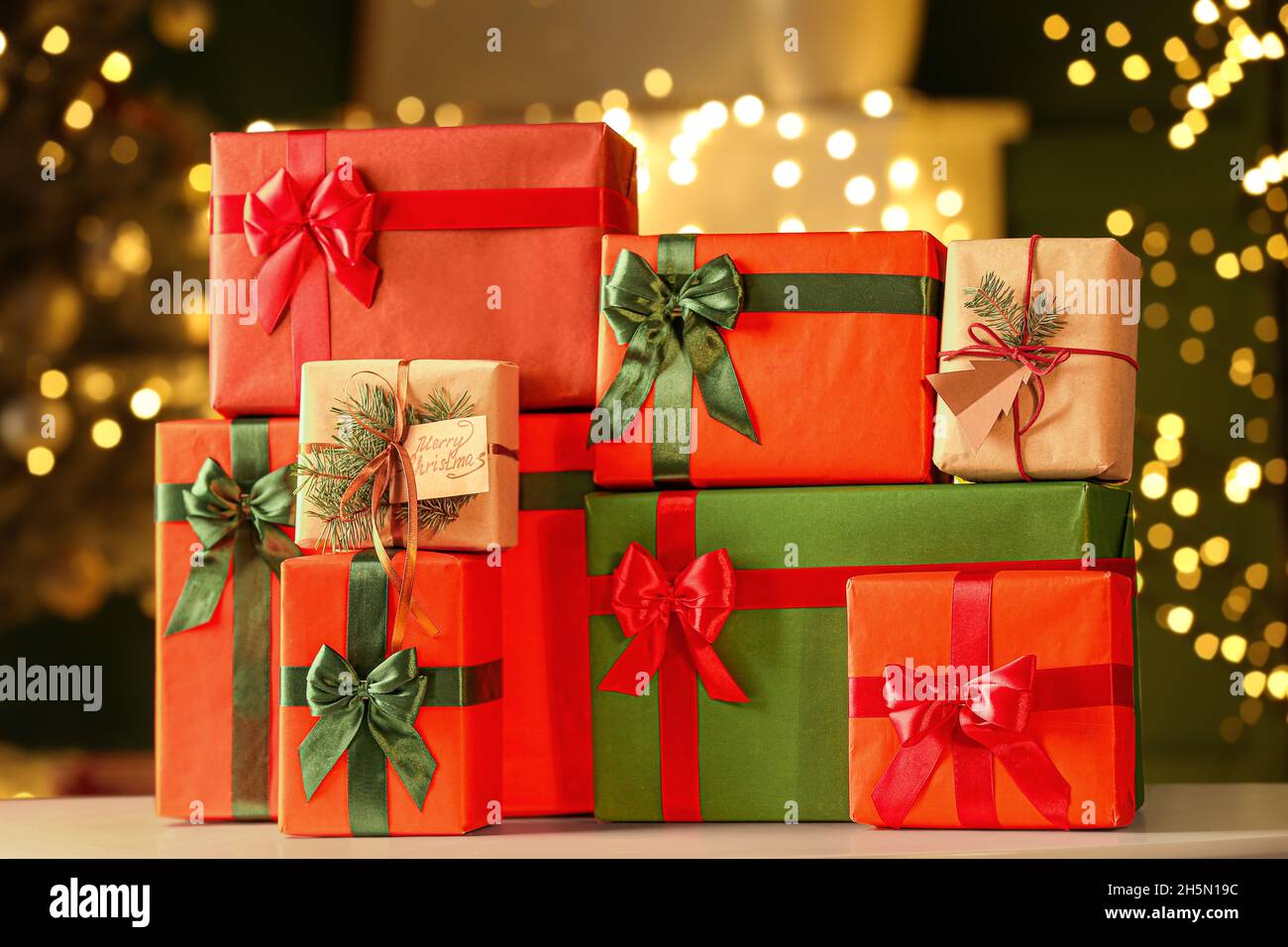 Christmas gift boxes on table in room Stock Photo - Alamy