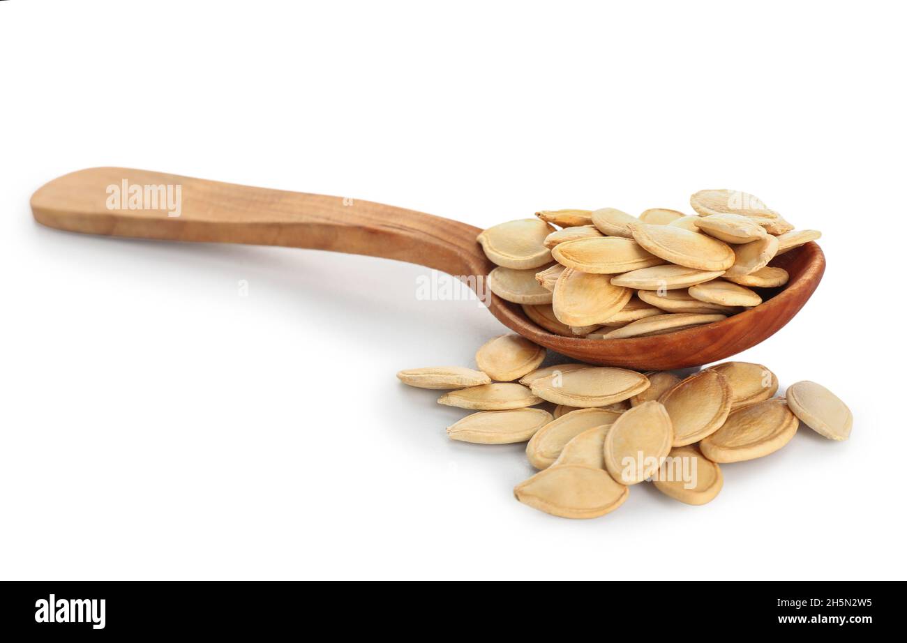 Spoon with natural pumpkin seeds on white background Stock Photo - Alamy