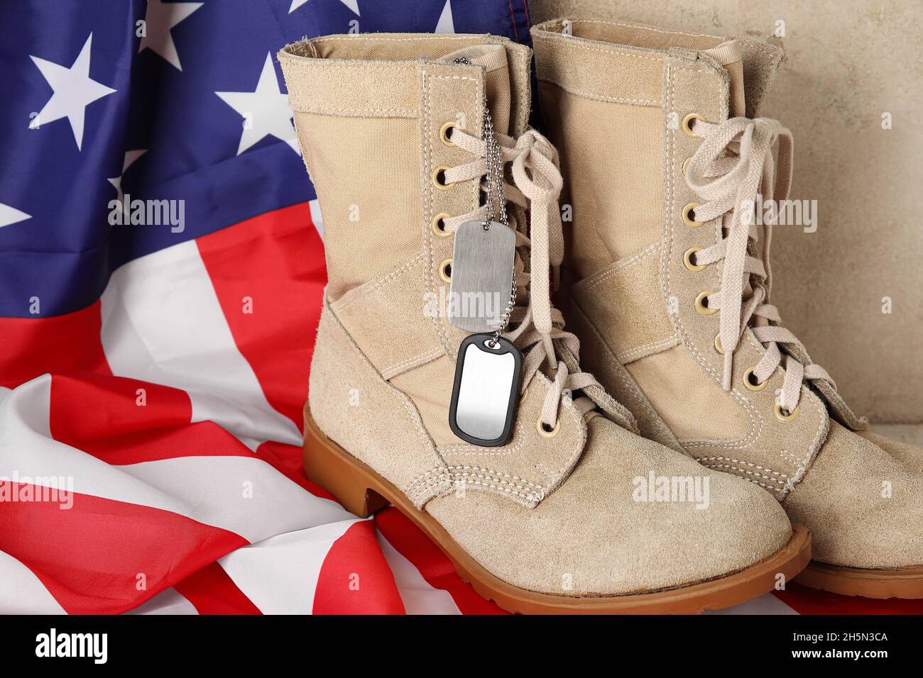 Military boots, tags and USA flag on light background Stock Photo - Alamy