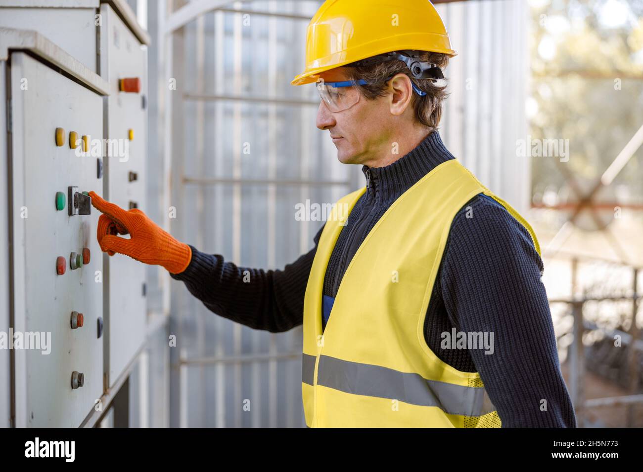 Factory employee using professional equipment hi-res stock photography ...