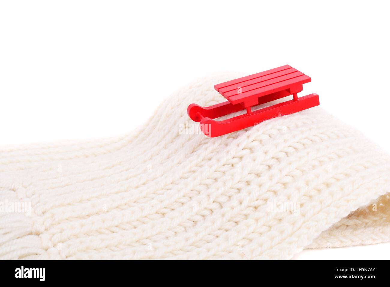 Tiny red sled on a scarf mountain Stock Photo - Alamy