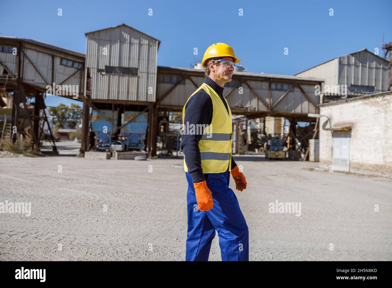 Male engineer standing outdoors at industrial site Stock Photo - Alamy