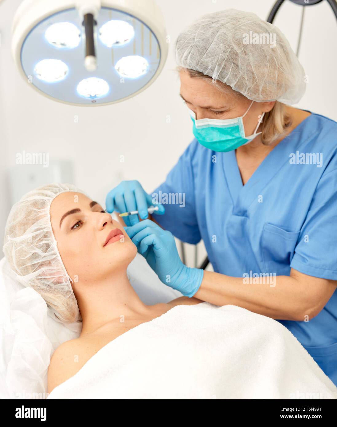 Portrait of woman during beauty facial injections in medical esthetic ...