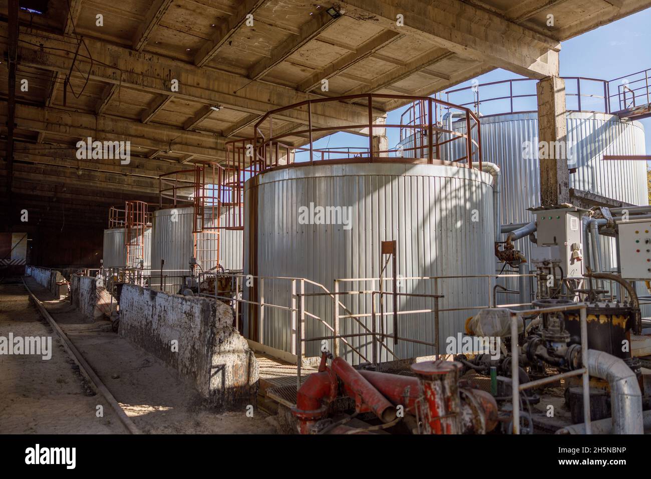 Industrial building with storage cylinders at factory Stock Photo - Alamy